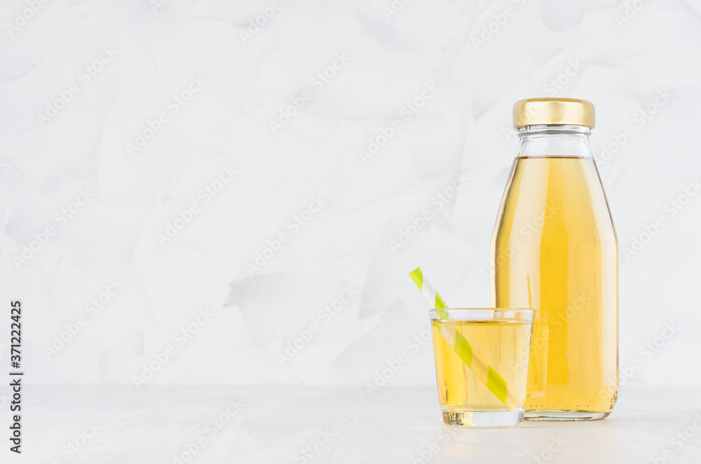 Fresh yellow transperent apple juice in glass bottle mock up with straw ...