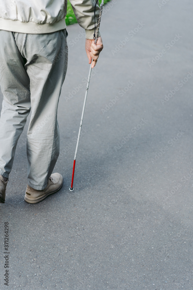 Visually impaired older man walking on path in nature Stock Photo ...