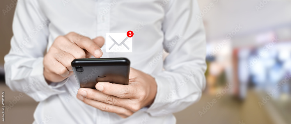Hand holding using mobile phone with email icon on screen. Concept of ...