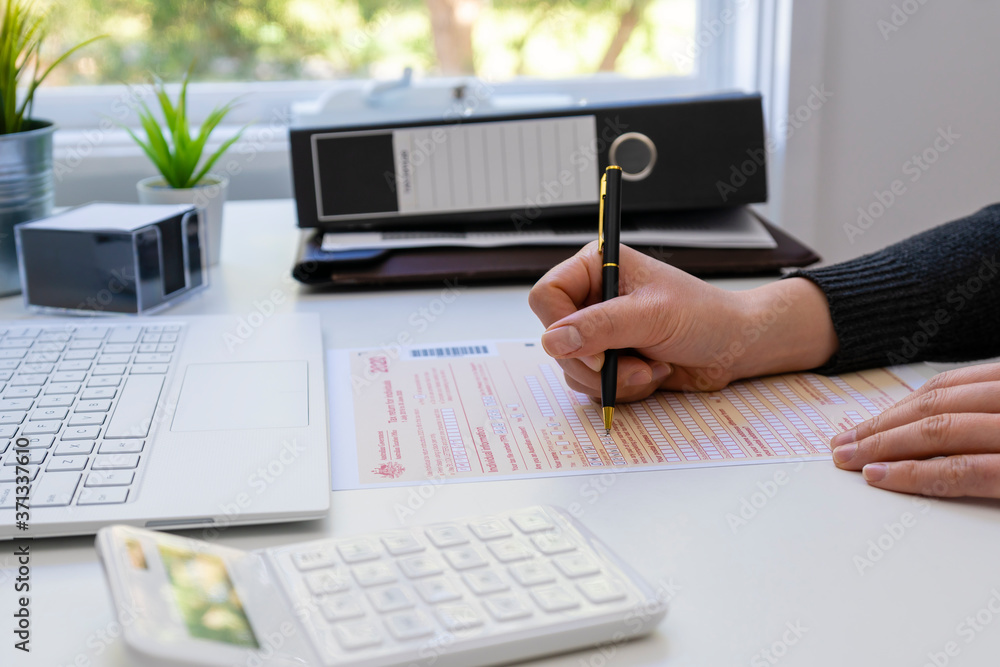 Completing Australian tax form Stock Photo | Adobe Stock Completing Australian tax form Stock Photo | Adobe Stock
