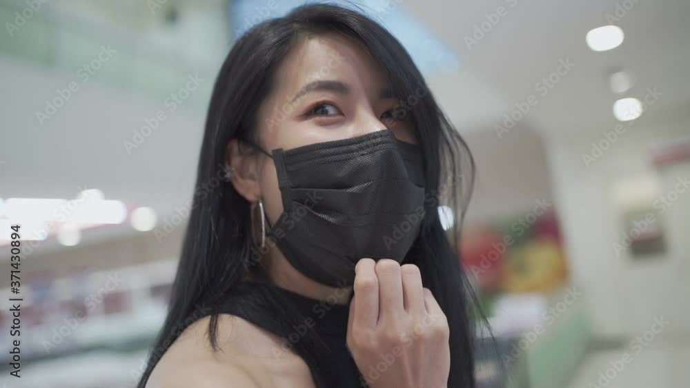 Vidéo Stock SLOW MOTION smile under face mask of Young attractive Asian ...