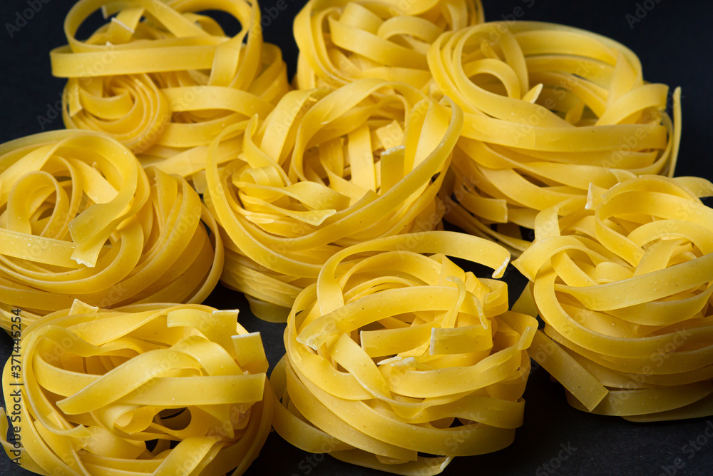 nests of pasta on a black background. Italian pasta. The pasta nests ...