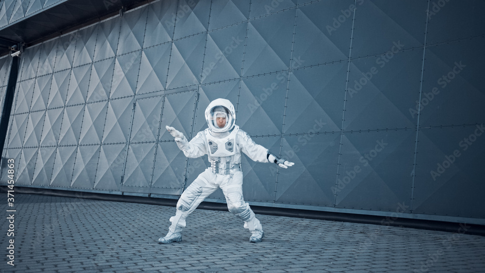Handsome Man in Spacesuit is Dancing Next to Metal Wall. Astronaut is ...