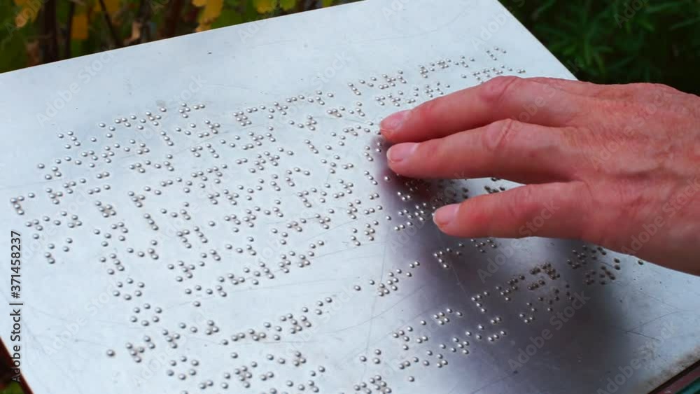 Hand touches the description in Braille. Typhlo pedagogue takes into ...