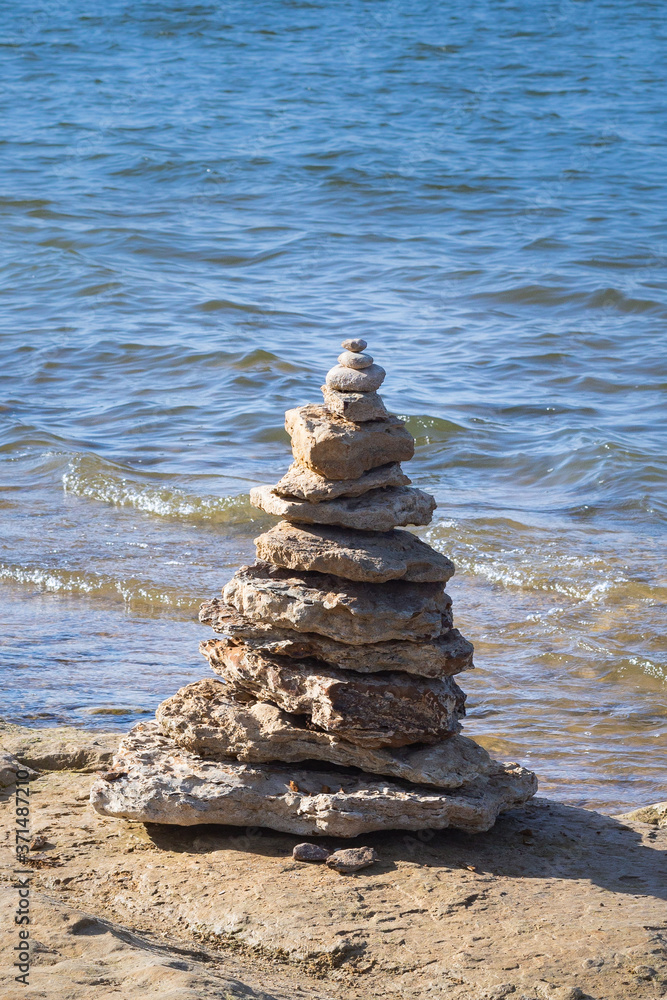 Balanced Rock Stack found on Shore of Lake with lapping waves behind ...
