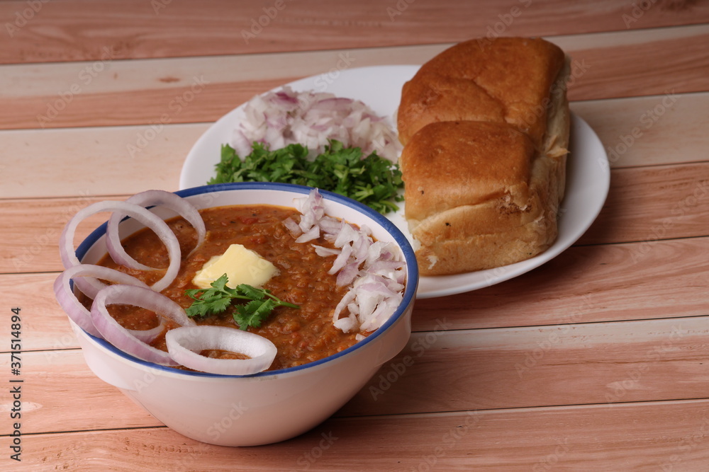 Pav Bhaji Indian spicy fast food with bread, onion and butter, Indian ...