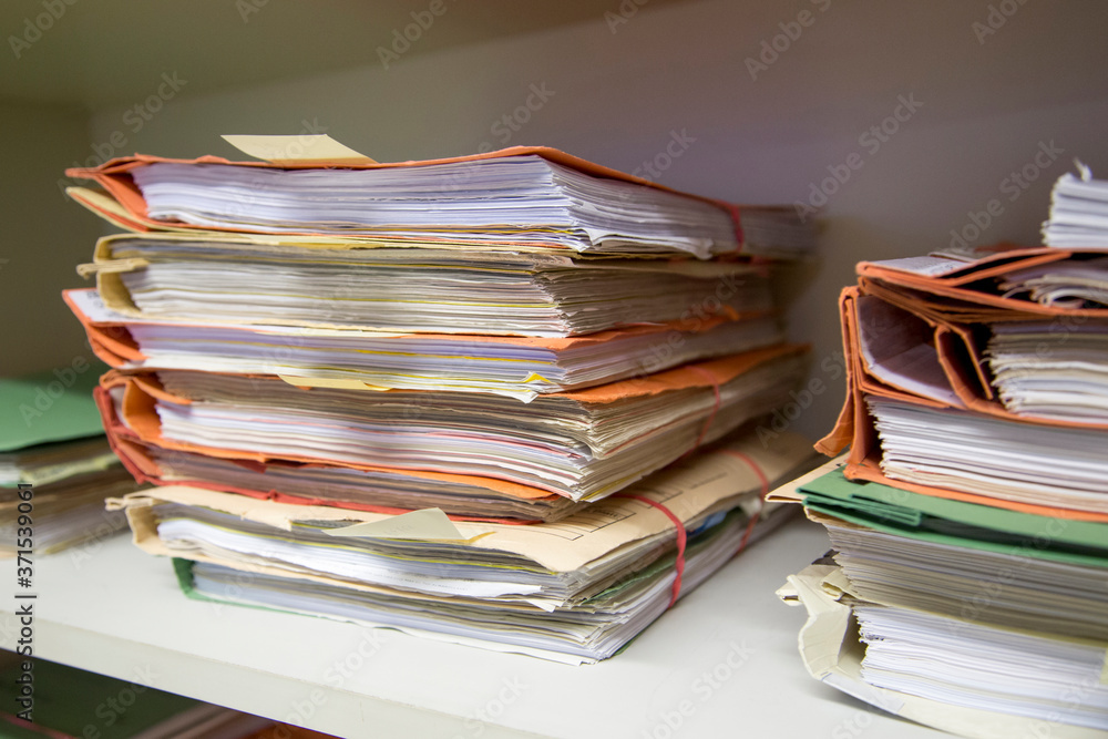 good old days of piles of files and bureaucracy, a pile of files in ...