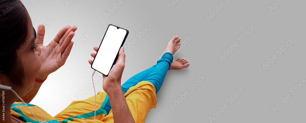girl watching mobile phone with hand gestures and wearing earphone ...