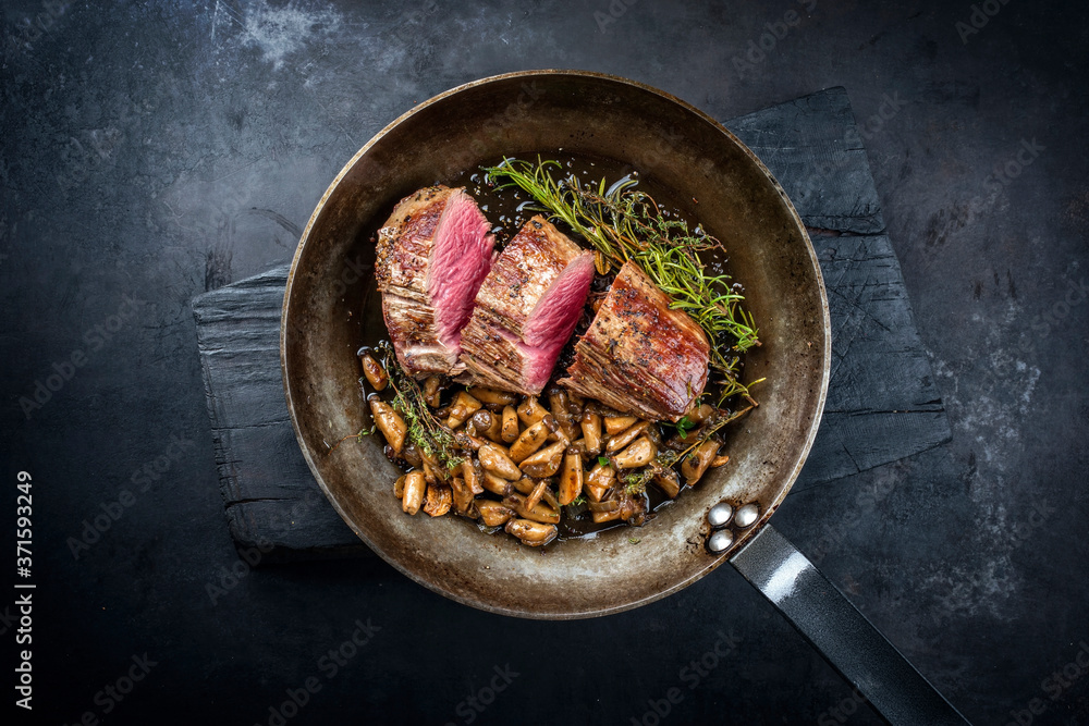 Fried dry aged beef fillet steak natural with king trumpet mushroom and ...