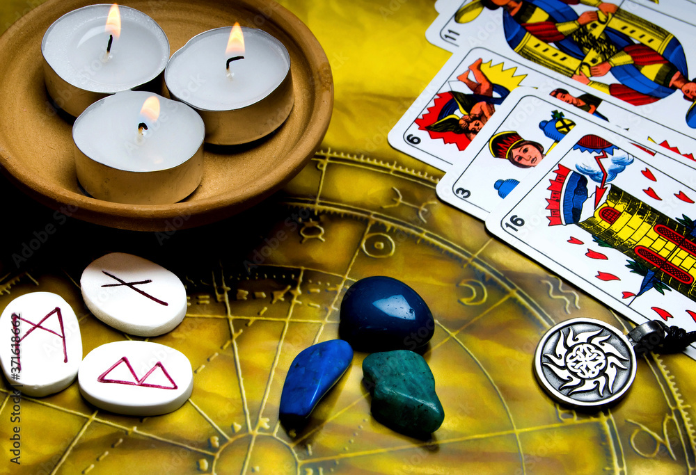esoteric, fortune teller and magic tools candles, runes, gem stones ...