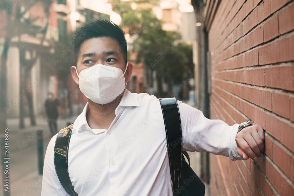 Young Asian man with face mask to protect and prevent from the spread ...