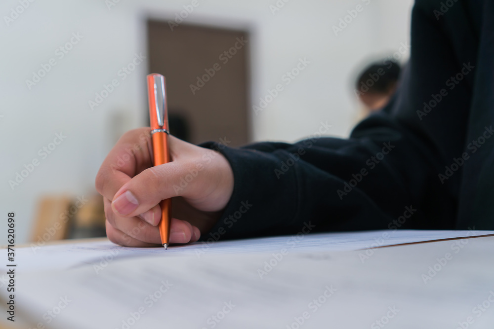 Hands Student testing in exam on exercise sheet, taking at school or ...