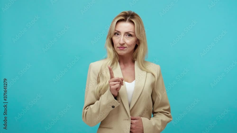Be careful. Strict and serious blond woman in business suit warning ...