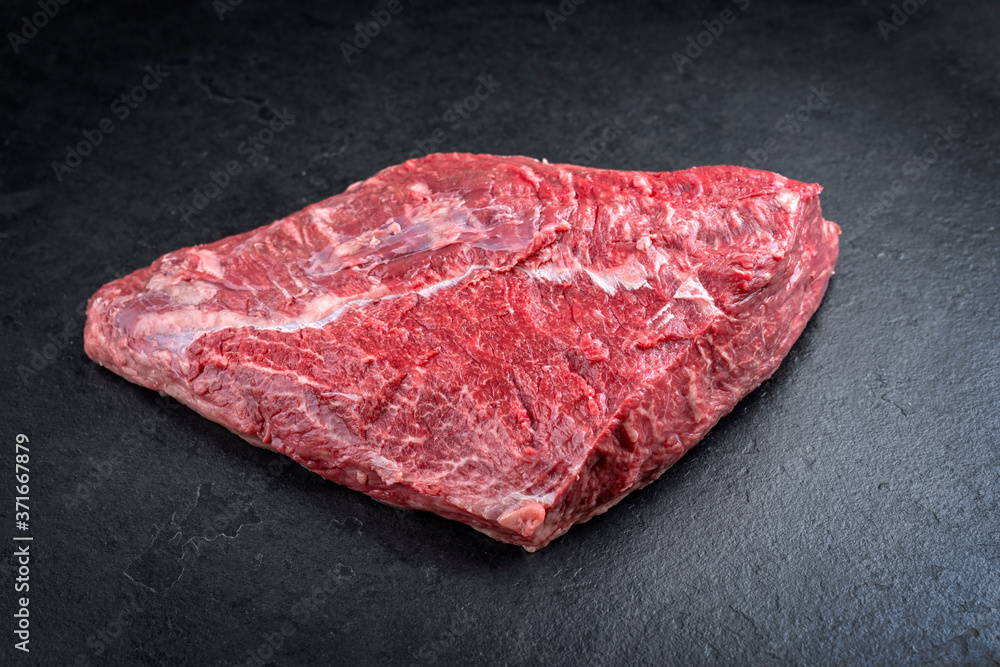 Raw dry aged wagyu cap of rump beef offered as close-up on black ...