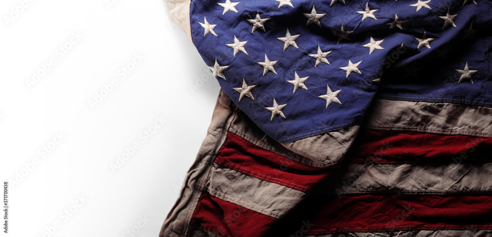 Wrinkled, aged, and worn US American flag with with blank white copy ...