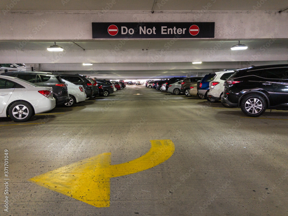 cars in commercial parking garage with Do Not Enter warning sign and ...