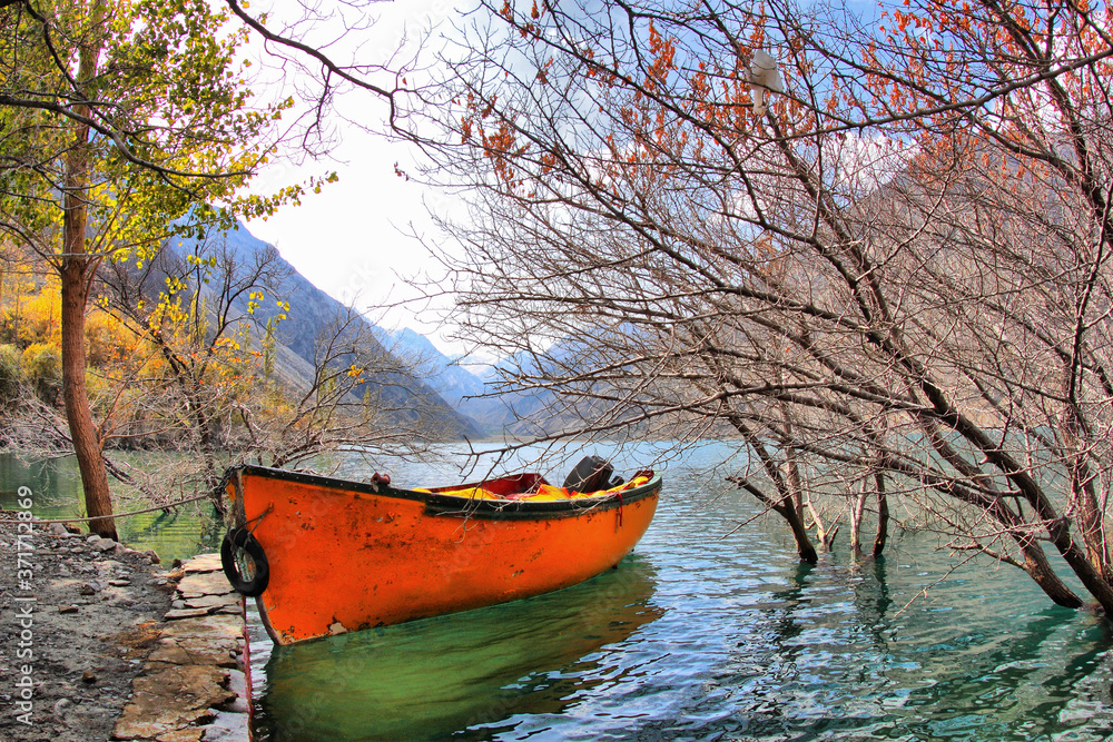 red boat in the lake , sadpara lake in autumn skardu , gilgit baltistan ...