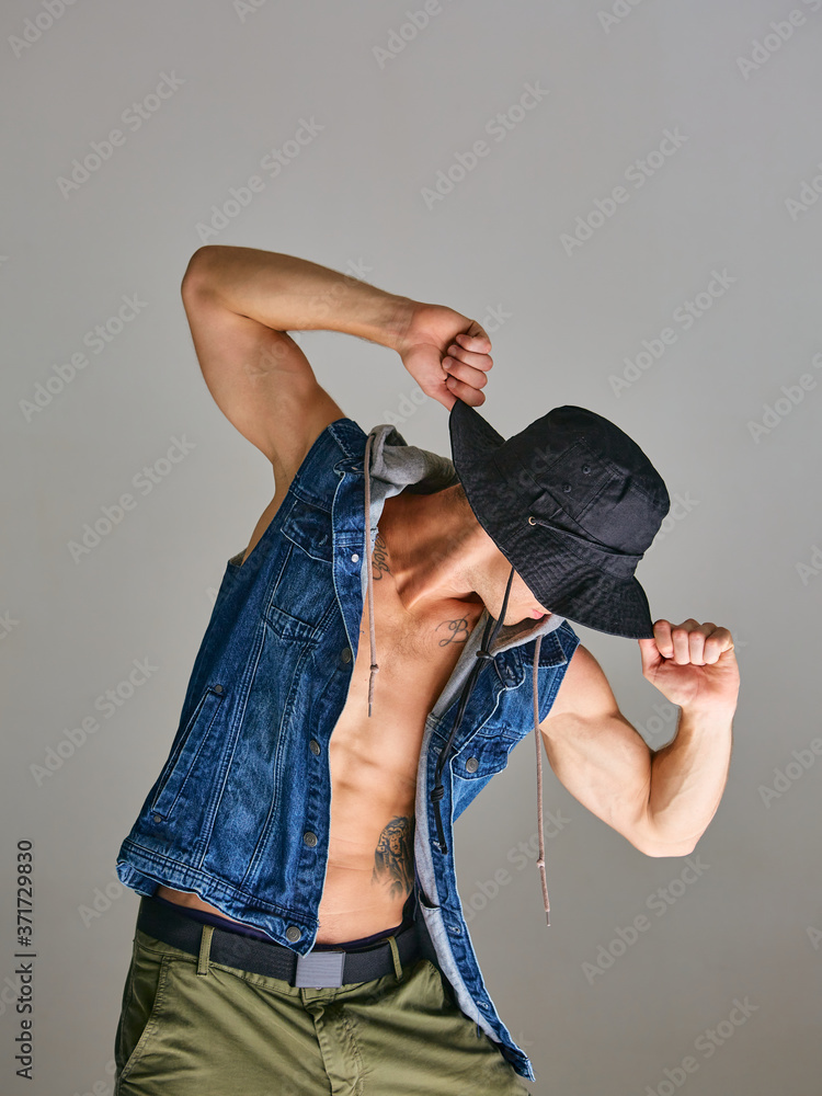 Cool guy breakdancer in panama hat dancing expressive dance in studio ...