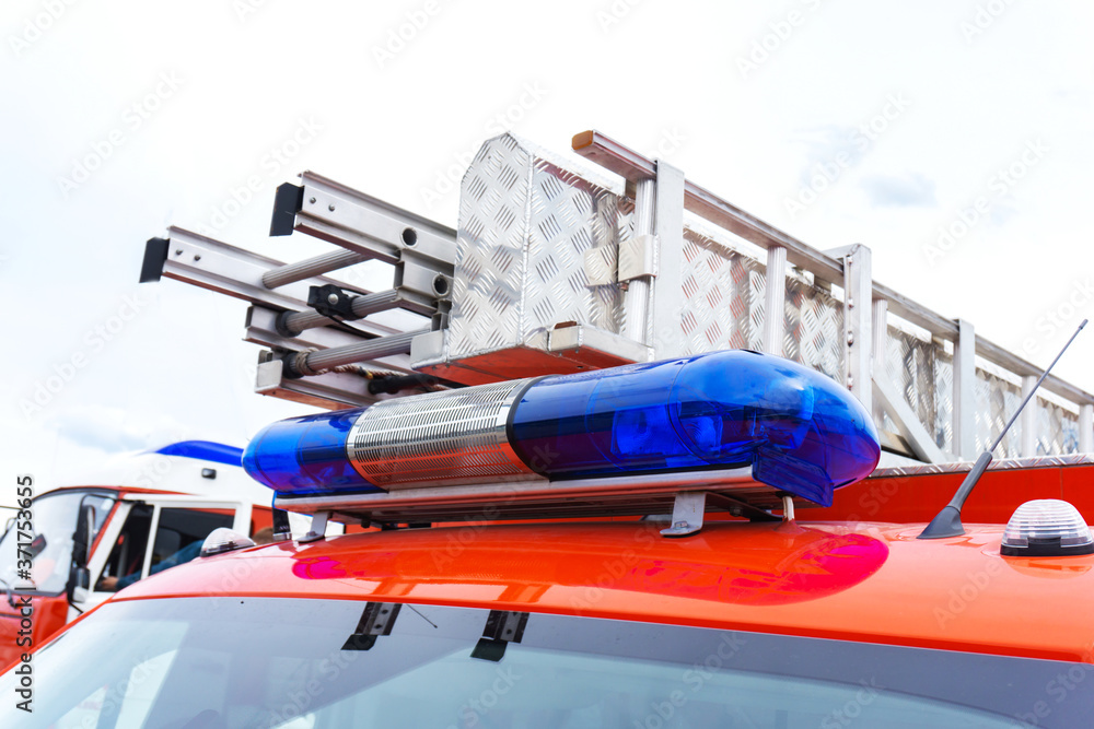 Fragment of a fire truck with a siren and a ladder. Fire truck with ...