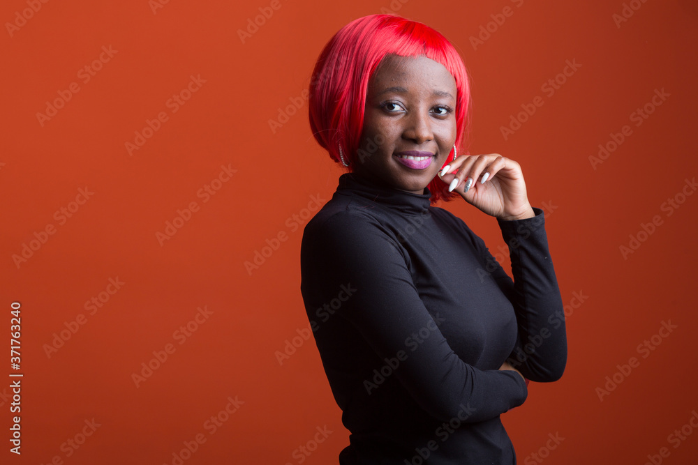 beautiful young african female with red hair on a red background Stock ...