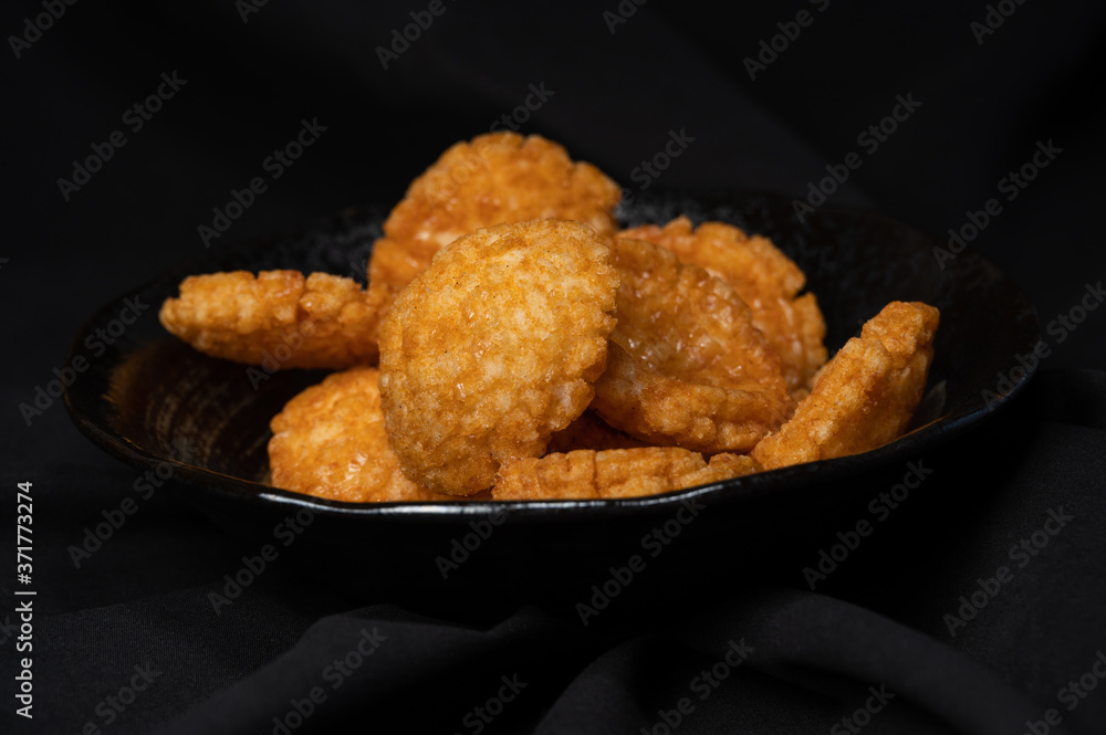 fried crispy rice crackers called rice age with soy,salt sugar etc ...