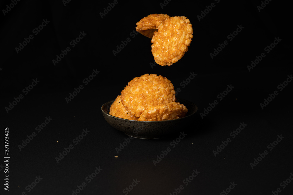 fried crispy rice crackers called rice age with soy,salt sugar etc ...