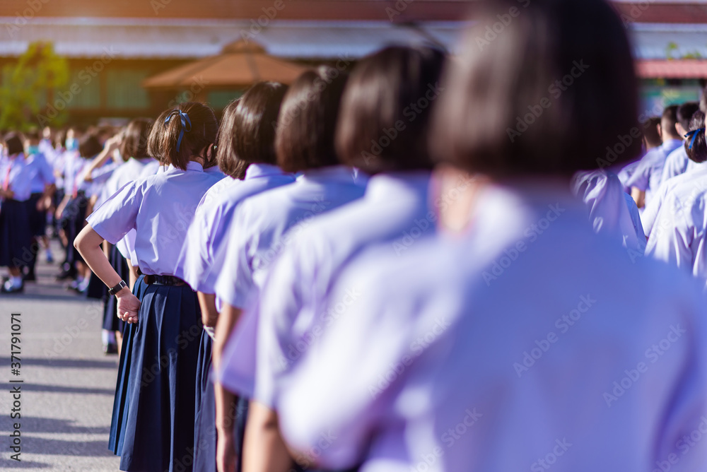 Asian hight school white uniform students stand in line to show respect ...