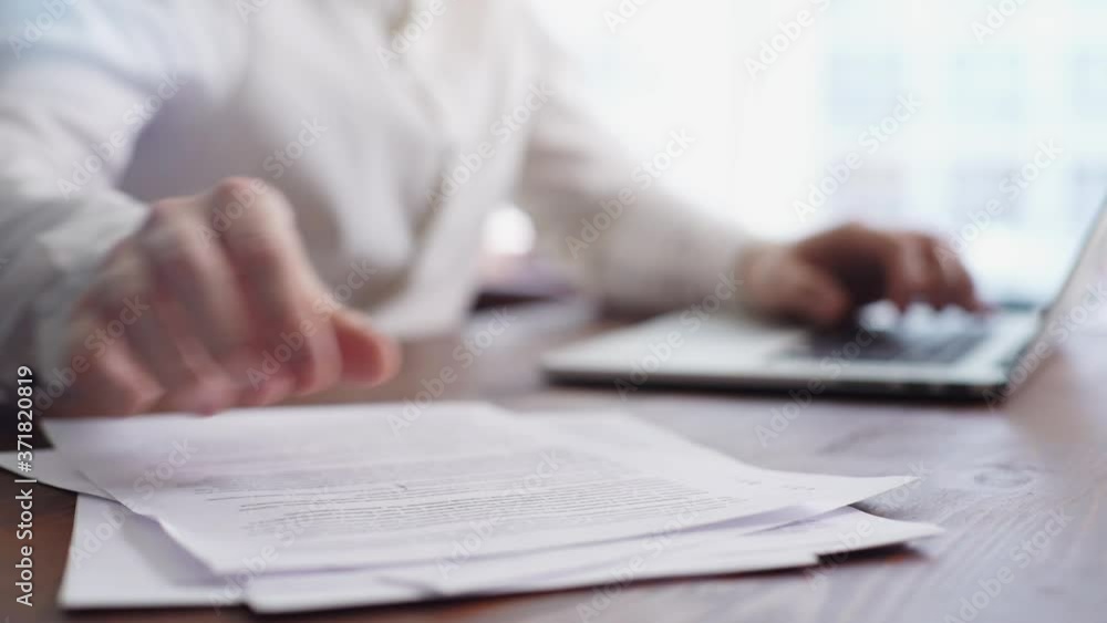Close-up of hands of unrecognizable business man typing on laptop and ...