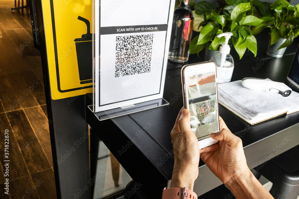 Modified inactive QR Code used. Person scanning QR code with smartphone ...
