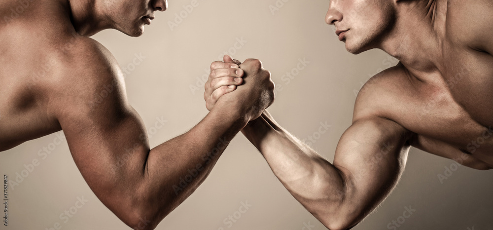 Two hands. Muscular men measuring forces, arms. Hand wrestling, compete ...
