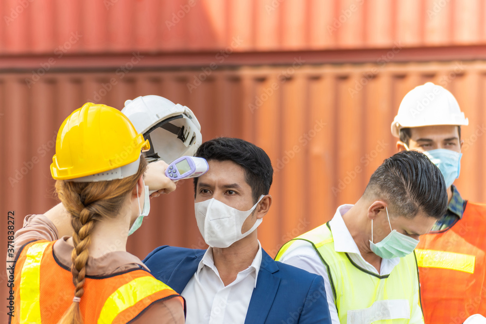 industrial worker woman temperature checking fever by digital ...