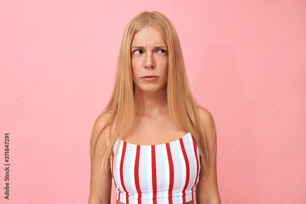 Isolated image of thoughtful serious young female with long fair hair ...
