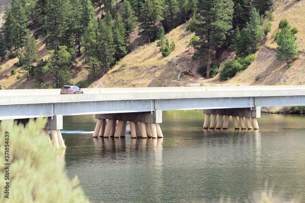 Car crosses a concrete bridge over the Missouri River in Montana. Stock ...