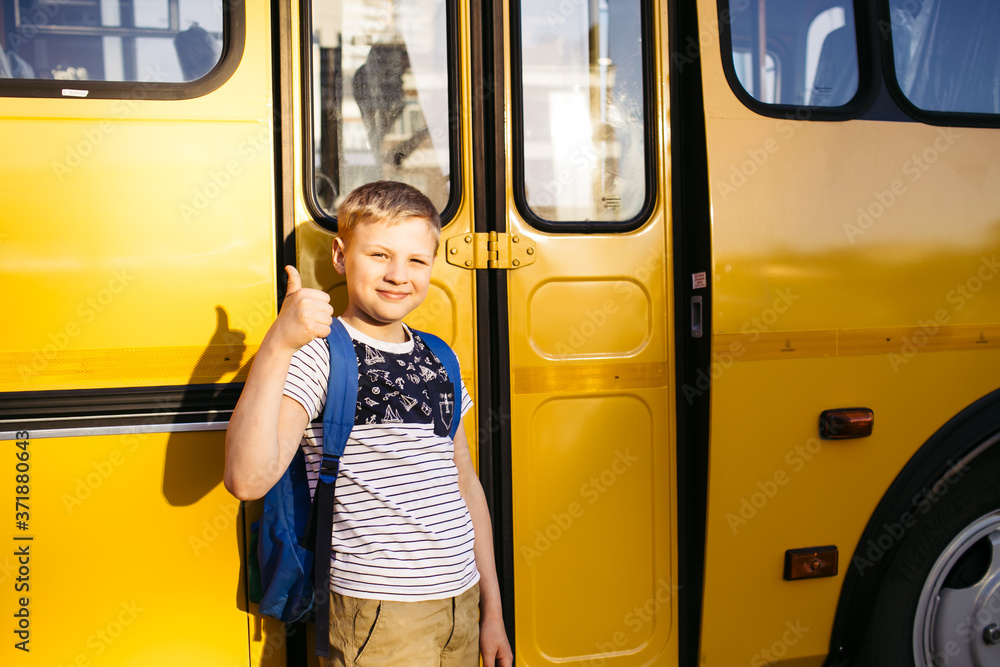 Happy boy in front of school bus. Back to school. Education. Day of ...