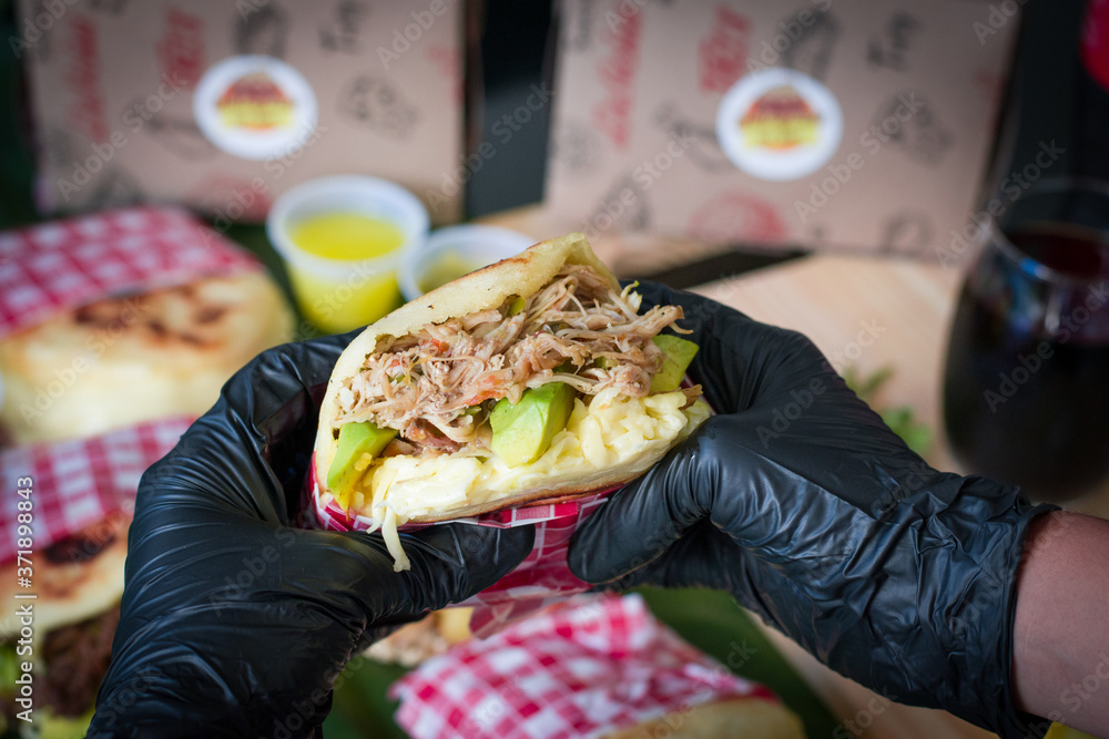 person with arepa in hands, person eating arepas, person showing arepa ...