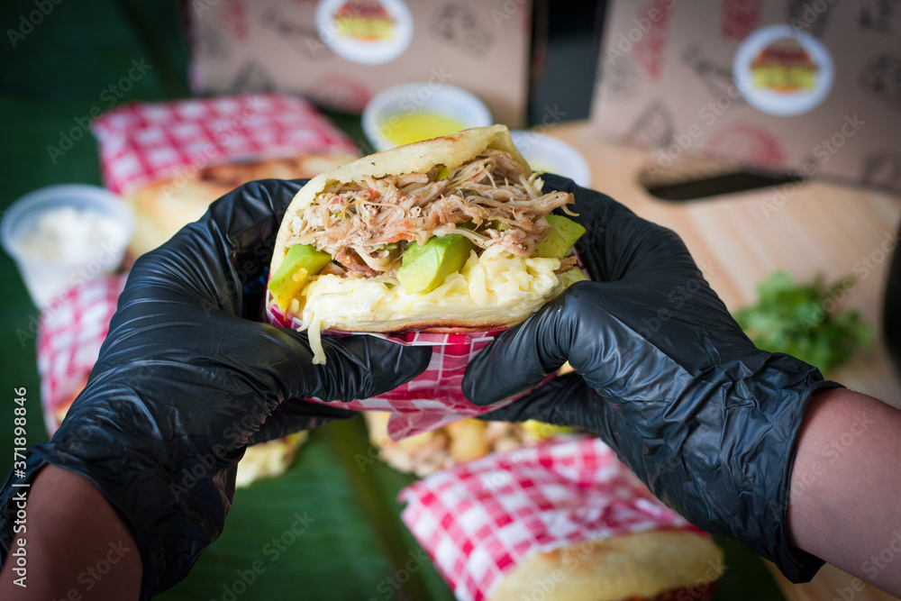 person with arepa in hands, person eating arepas, person showing arepa ...