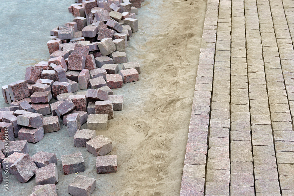 Repair of a pedestrian road. Laying street tiles. Gentrification of the ...