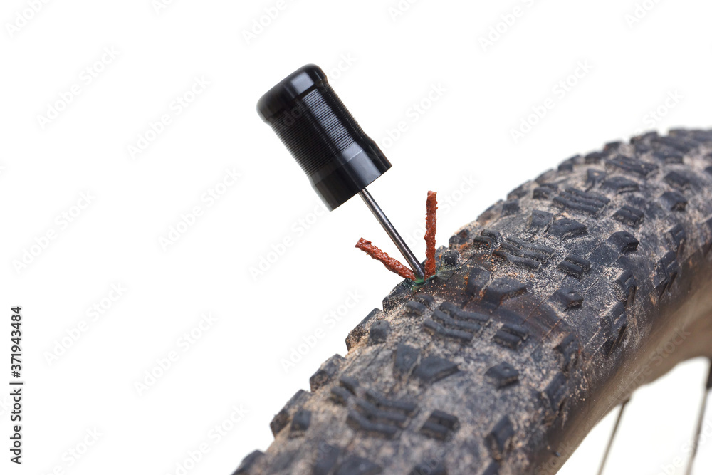 Mountain bike tire puncture repaired using a glue strip isolated on ...