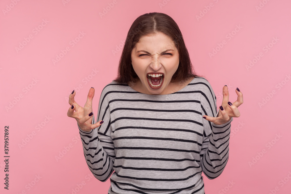 Hate this! Portrait of crazy aggressive woman in striped sweatshirt ...
