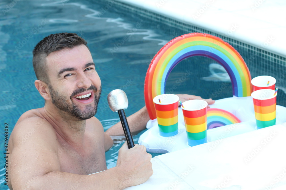 Cute man holding microphone in swimming pool Stock Photo | Adobe Stock