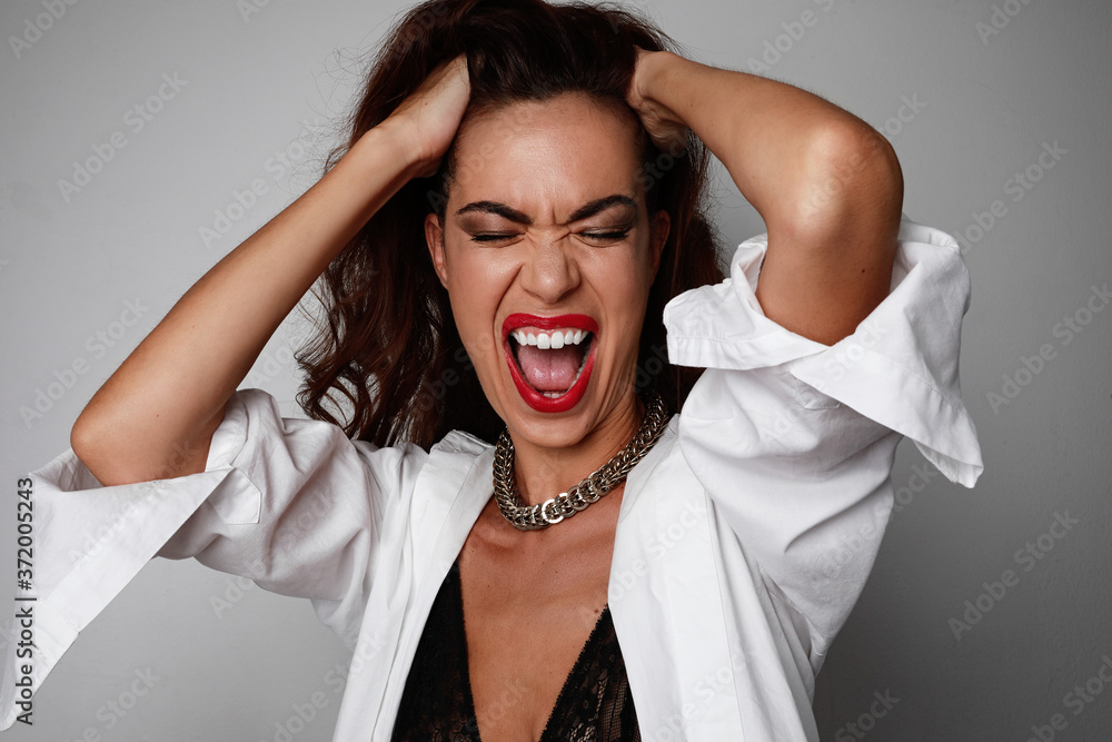 Screaming, and emotional angry woman screaming. Female half-length ...