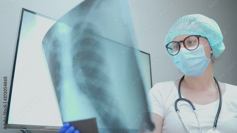 female doctor therapist examines the fluorography. woman pulmonologist ...