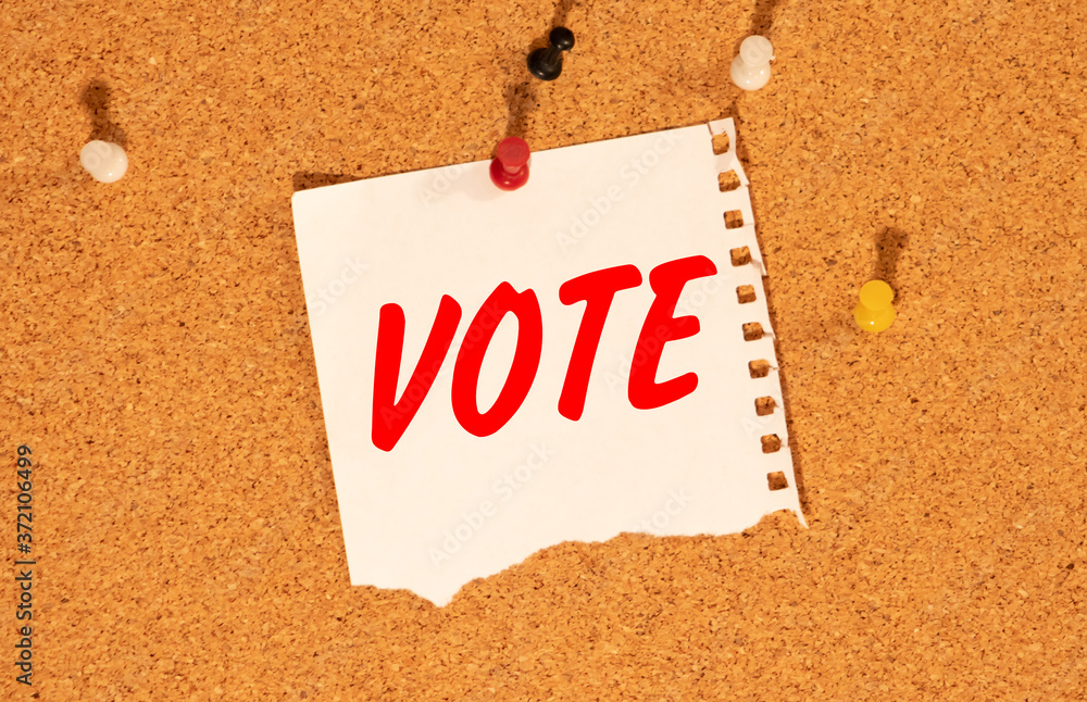 hand holding white paper with the vote and green check mark voting ...