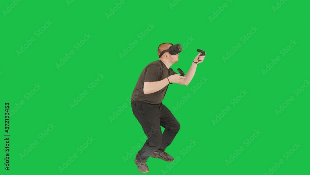 Greenscreen of young guy playing interactive virtual reality computer ...