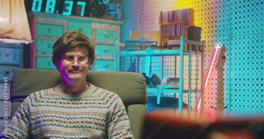 Caucasian weeping young man nerd in glasses and with mustache sitting ...