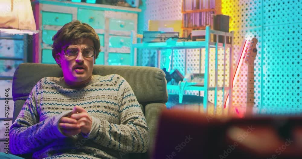 Caucasian afraid young man nerd in glasses and with mustache sitting in ...