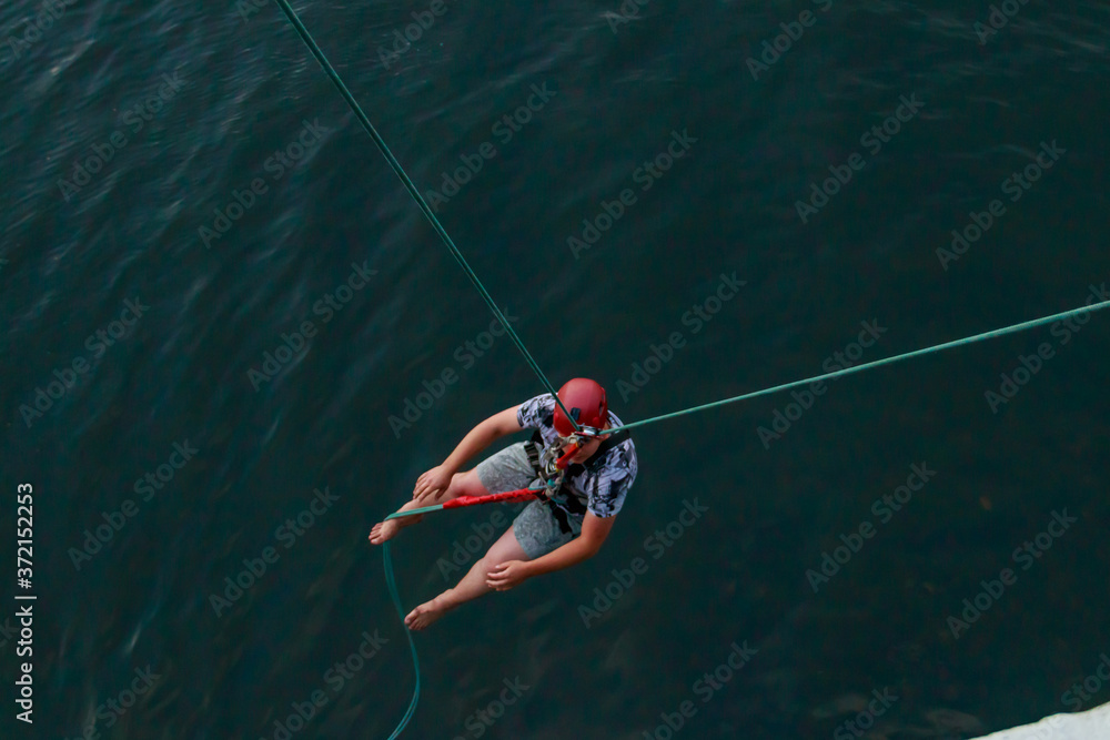 Rope jumping from high altitude of bridge. Bungee jumping from ...
