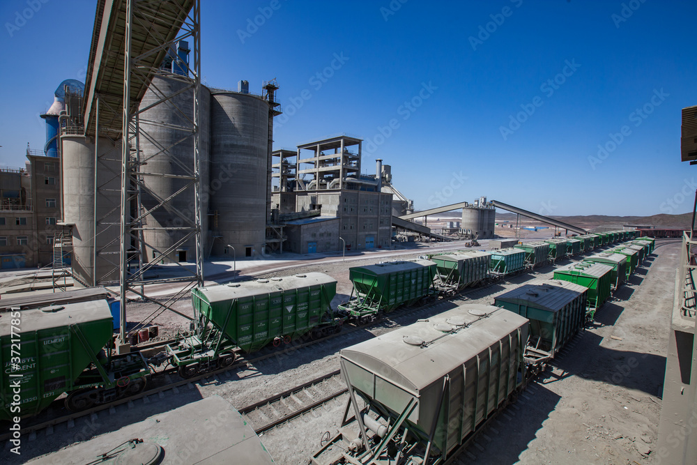 Mynaral/Kazakhstan: Modern cement plant in desert. Hopper cars on ...