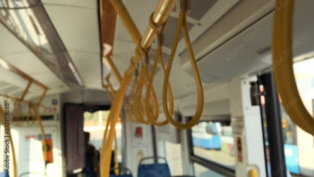 Vidéo Stock Hanging handrails in a bus. Plastic yellow grip on strap in ...