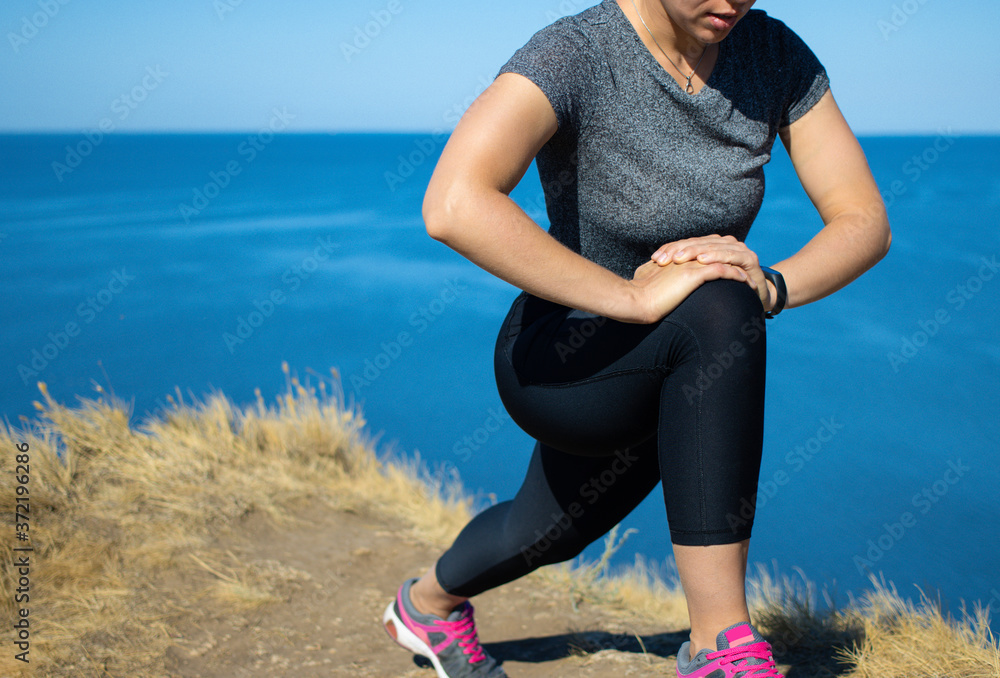 Athlete jogger woman stretching legs and thigh muscles doing lunge ...